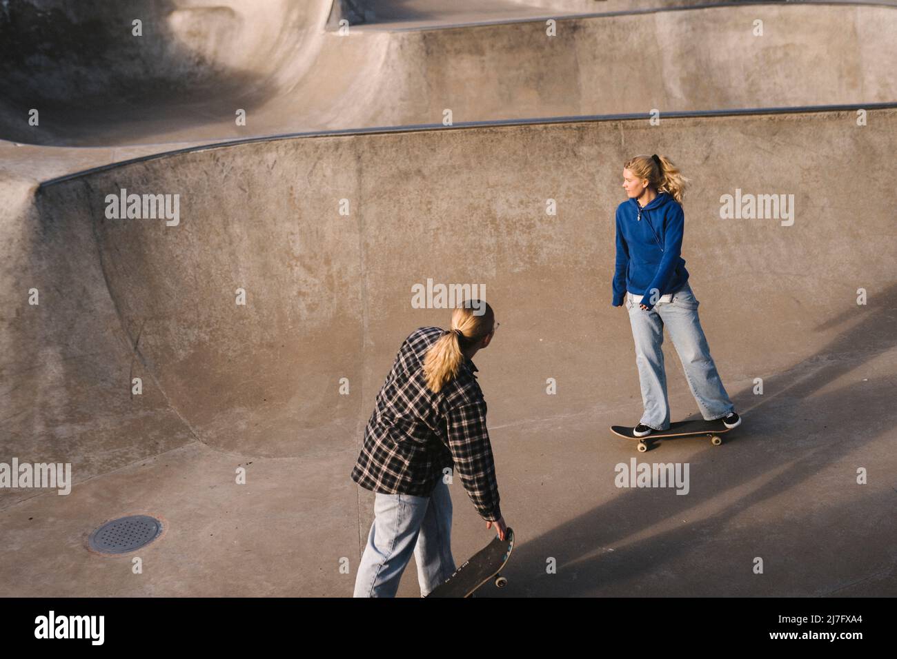 Teenage girls skateboarding in skatepark Stock Photo - Alamy