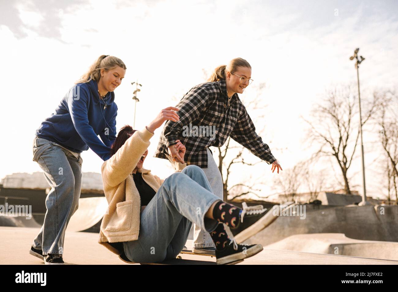 Teenage girls skateboarding in skatepark Stock Photo - Alamy