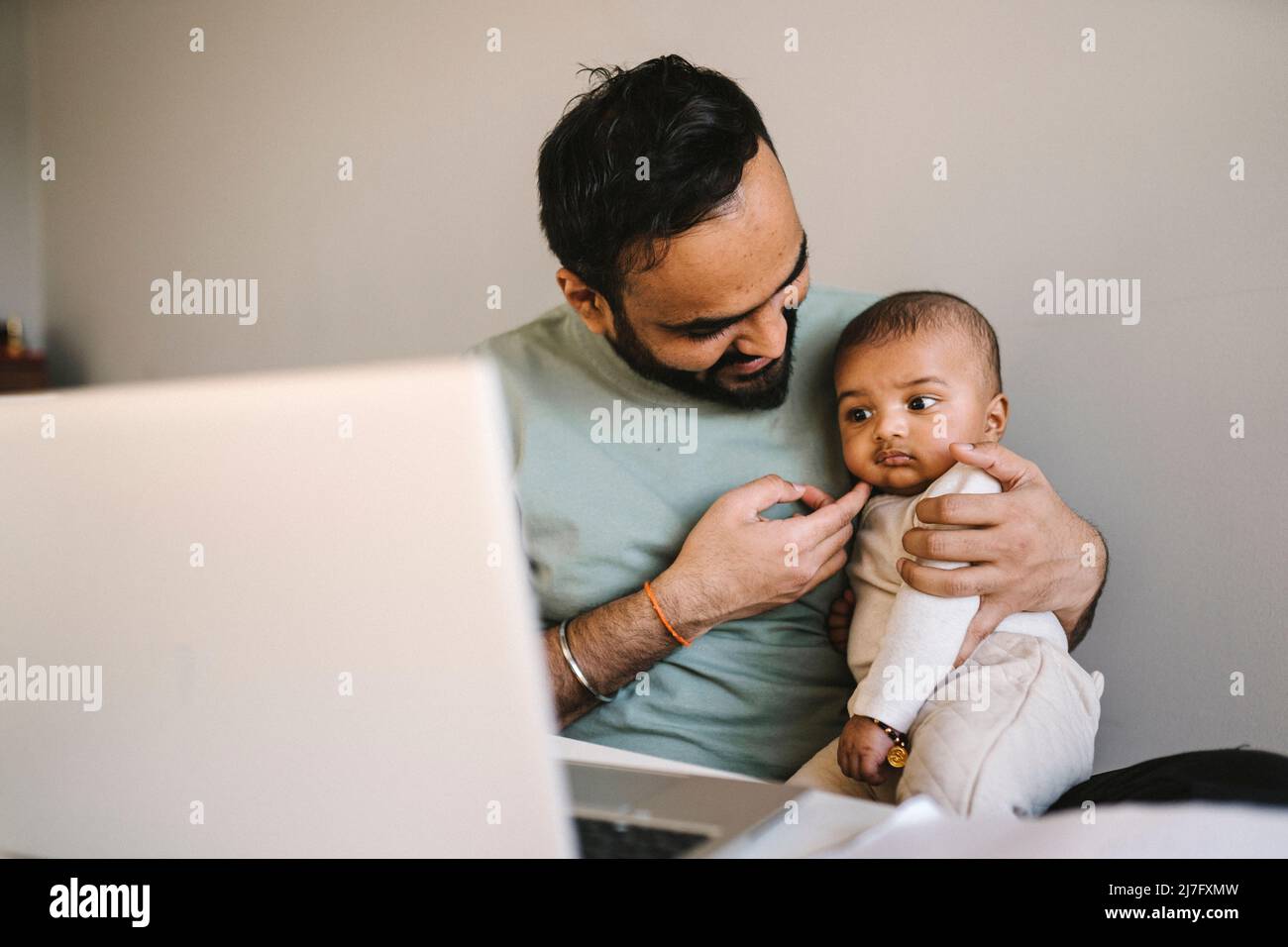 Father with baby working from home Stock Photo - Alamy