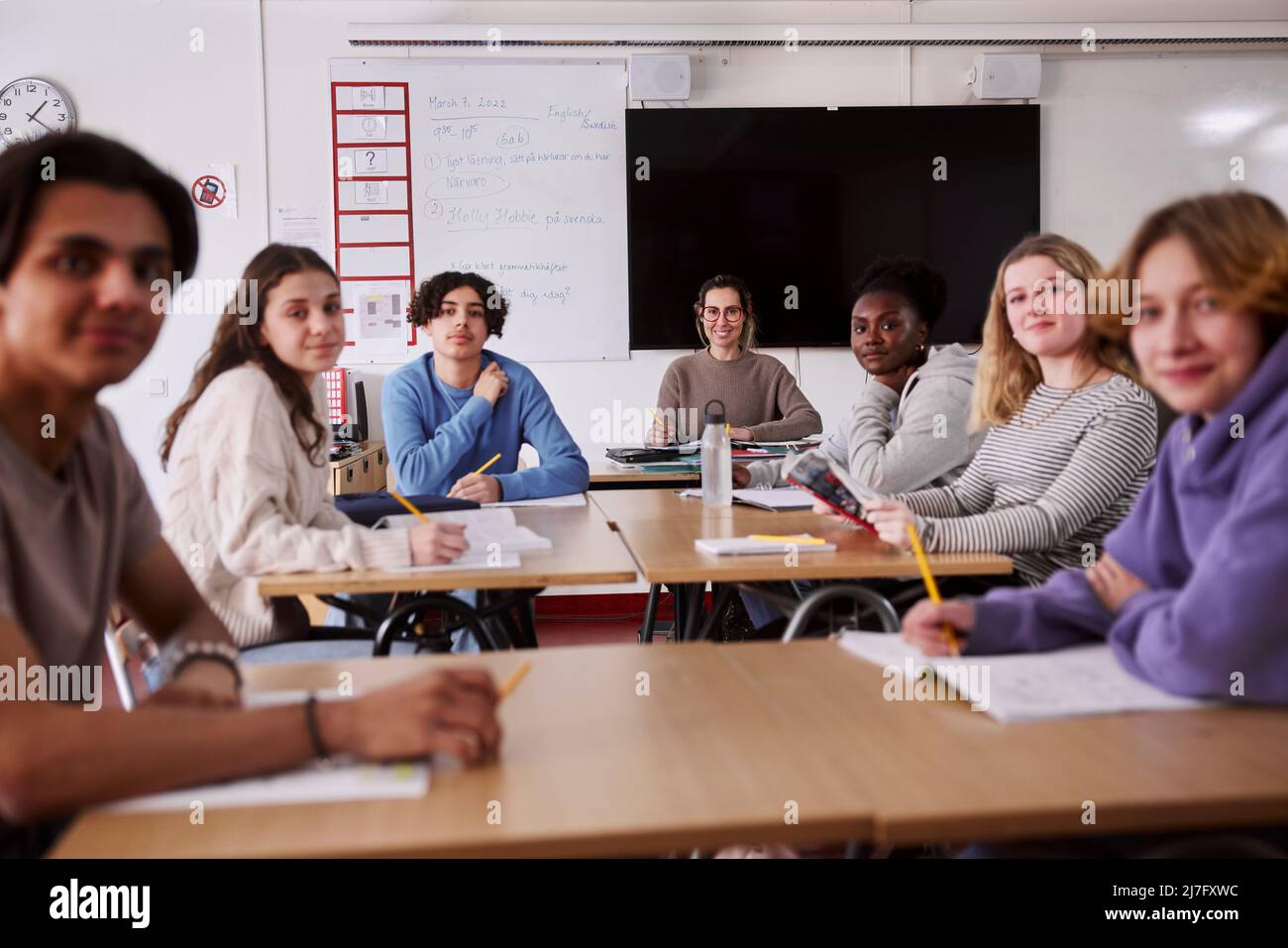 Teenagers in classroom Stock Photo - Alamy