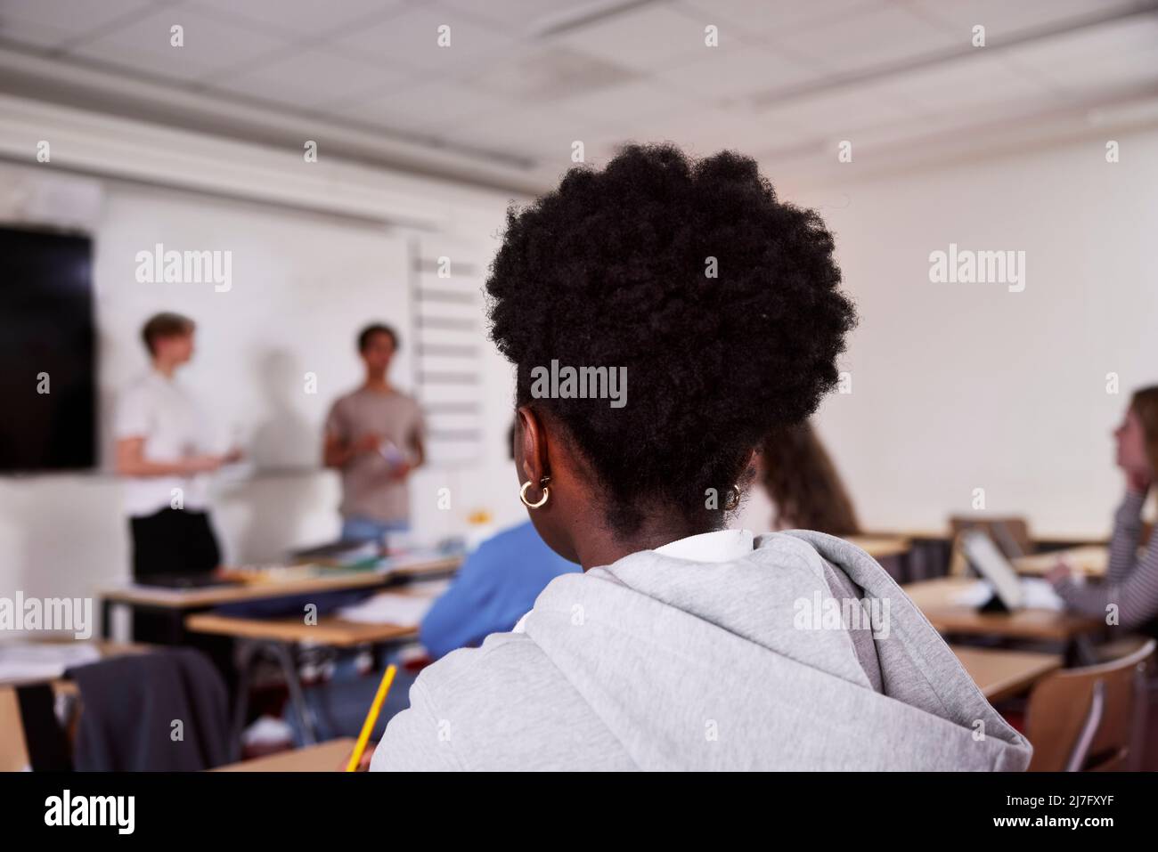 Teenage girl sitting in classroom Stock Photo - Alamy