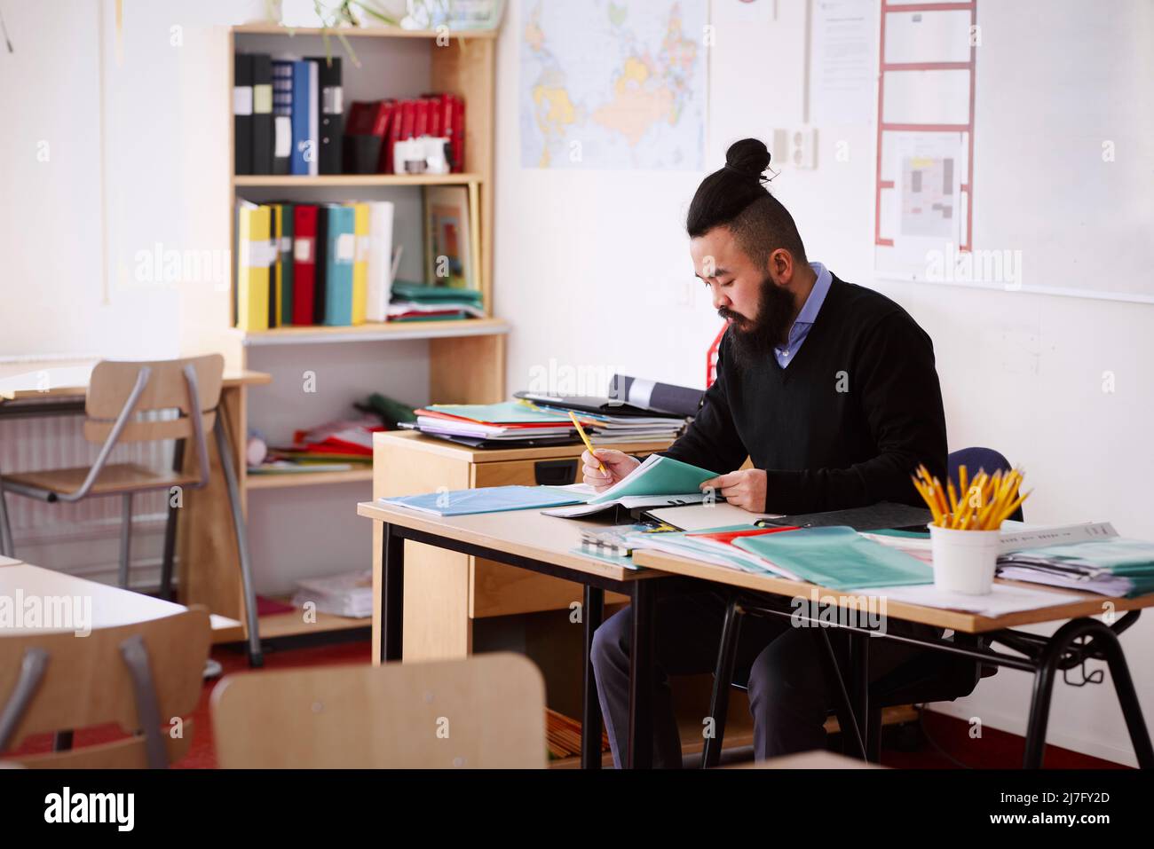 Teacher working in classroom Stock Photo - Alamy