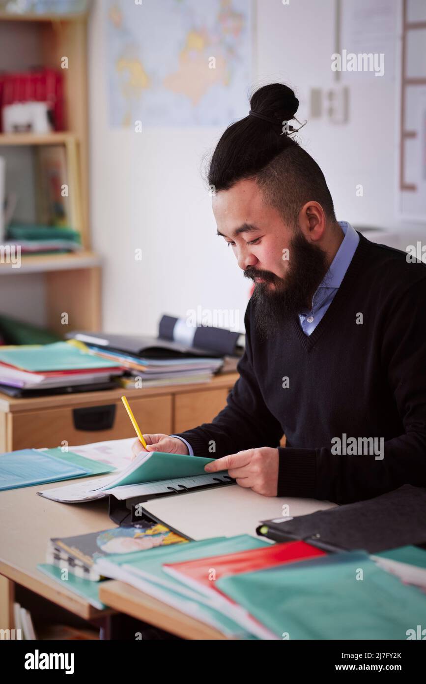 Teacher working in classroom Stock Photo - Alamy