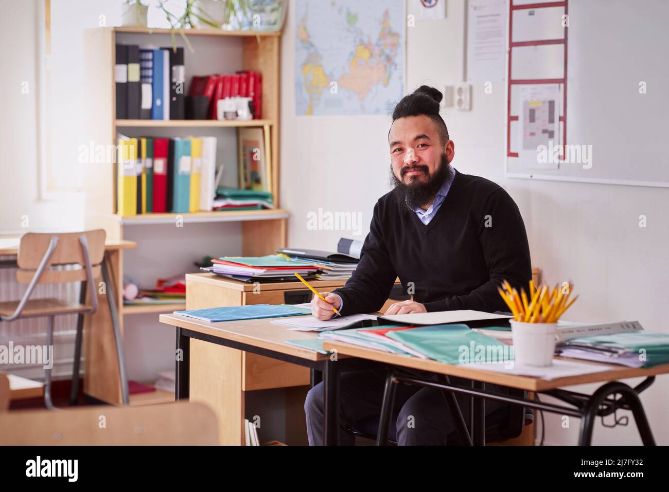 Teacher working in classroom Stock Photo - Alamy