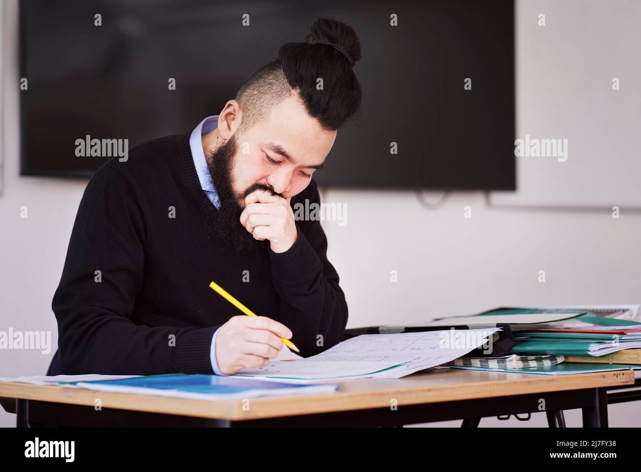Teacher working in classroom Stock Photo - Alamy