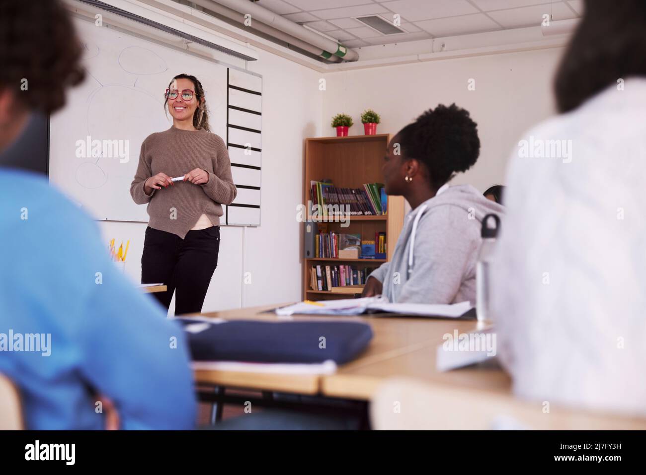 Female teacher in classroom Stock Photo - Alamy