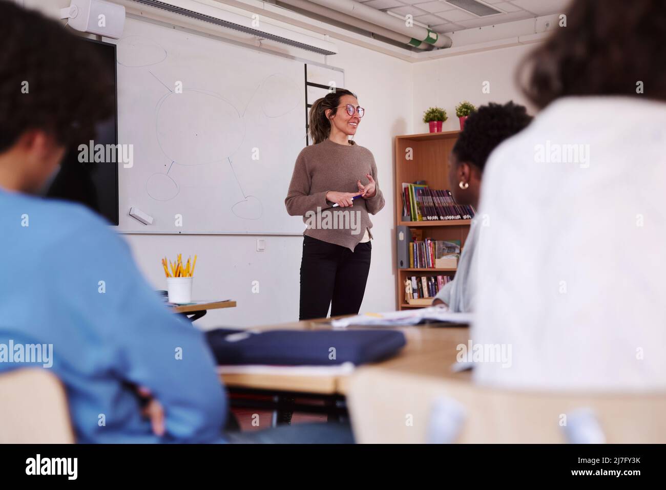 Female teacher in classroom Stock Photo - Alamy