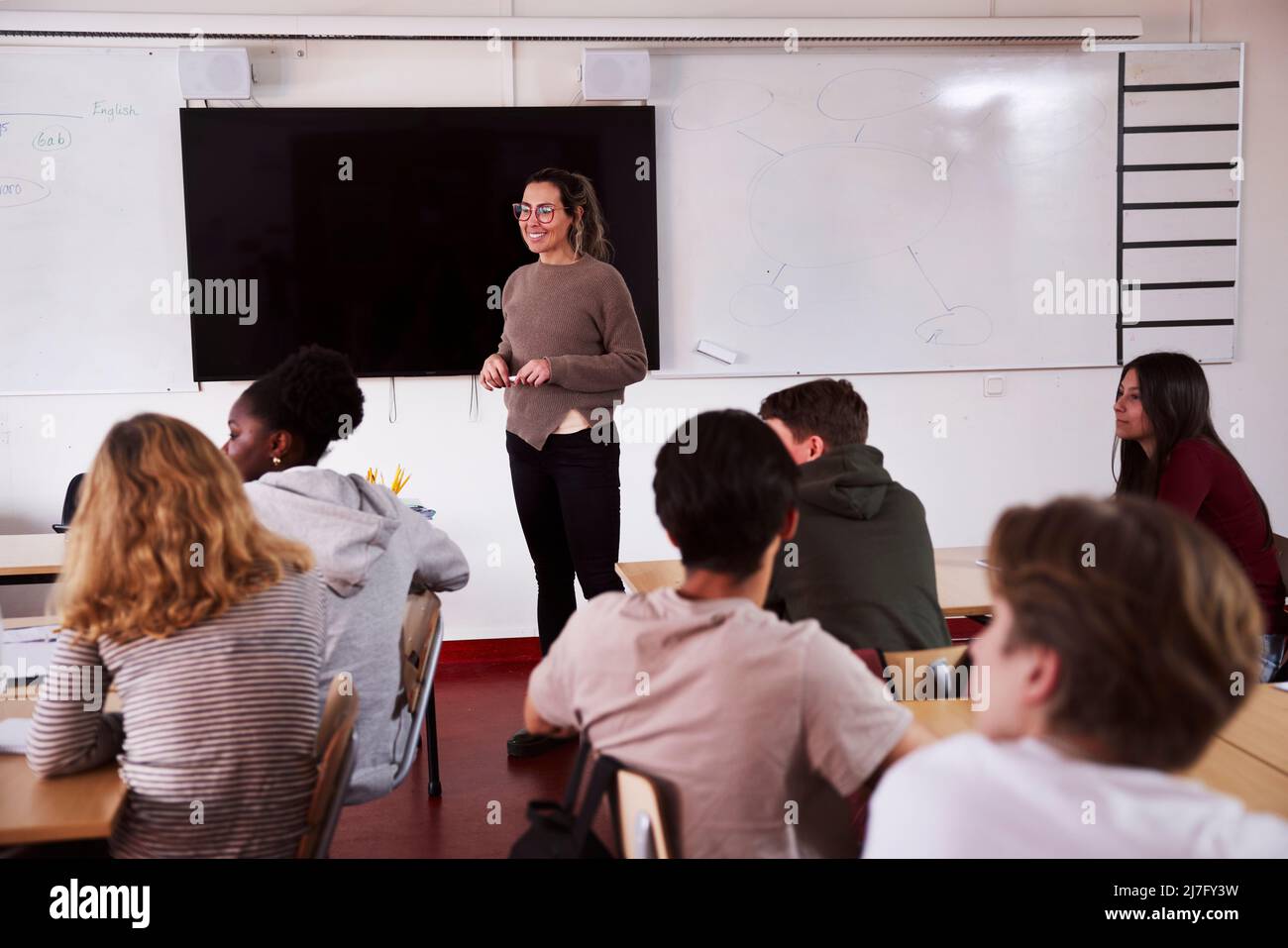 Female teacher in classroom Stock Photo - Alamy