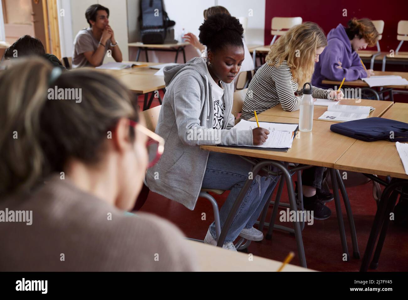 Teenagers in classroom Stock Photo - Alamy