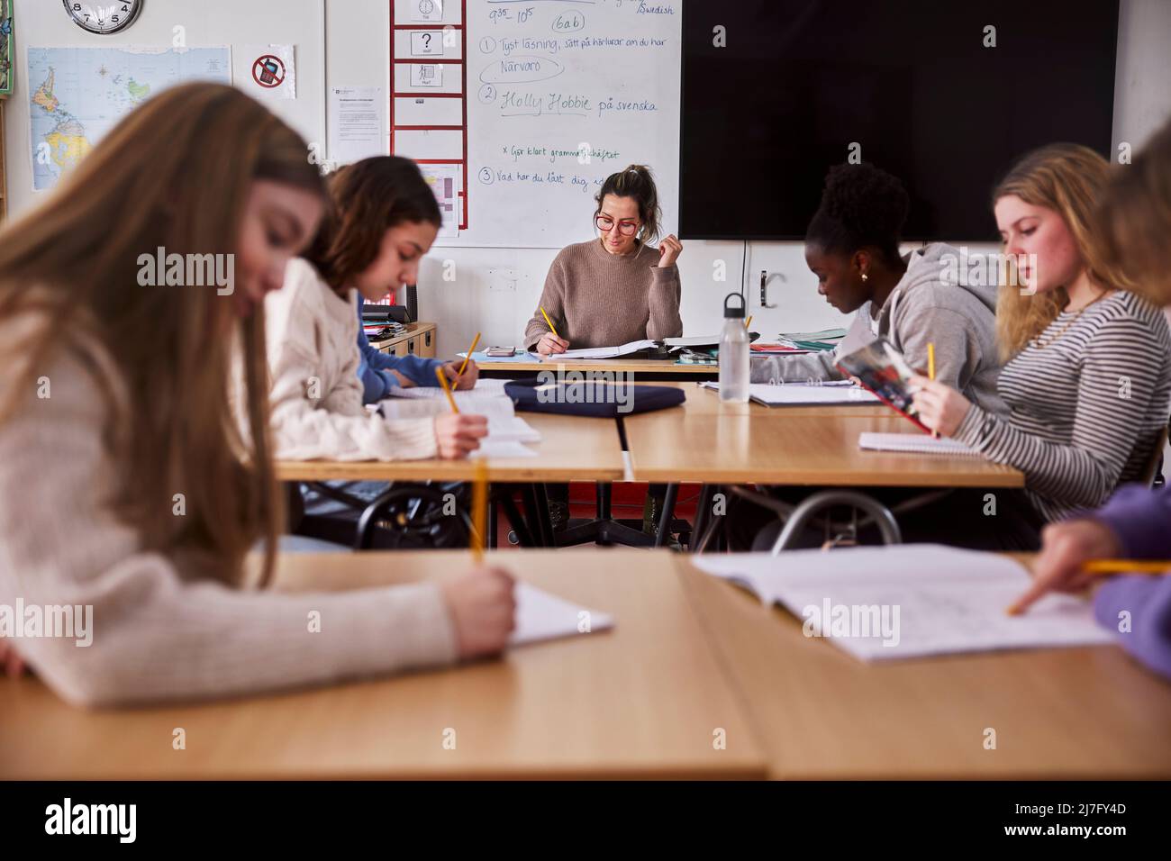 Teenagers in classroom Stock Photo - Alamy