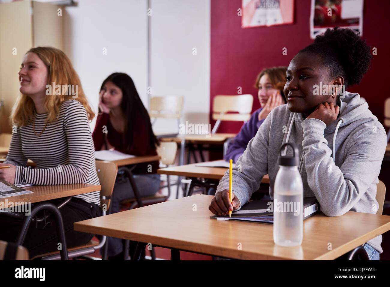 Teenagers sitting in classroom Stock Photo - Alamy