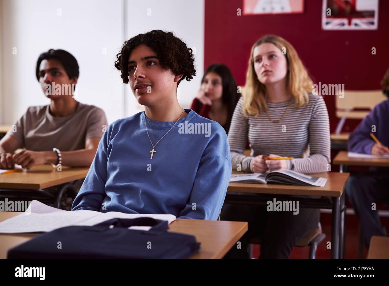 Teenage boy sitting in classroom Stock Photo - Alamy