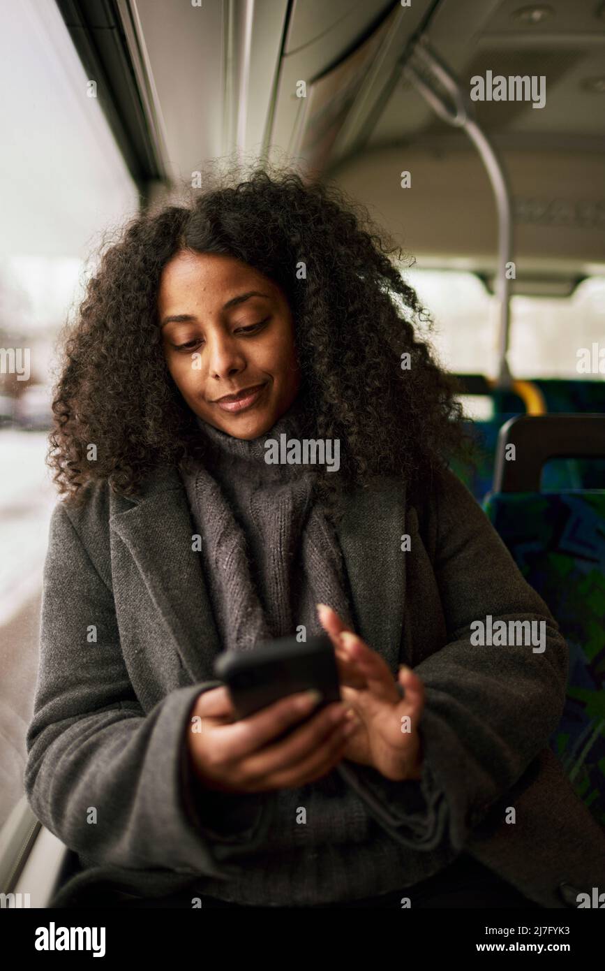 Woman in bus using cell phone Stock Photo - Alamy