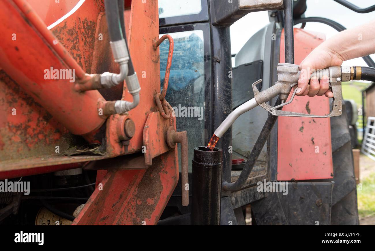 Farmer filling tractor with red Diesel on a farm, North Yorkshire, UK ...