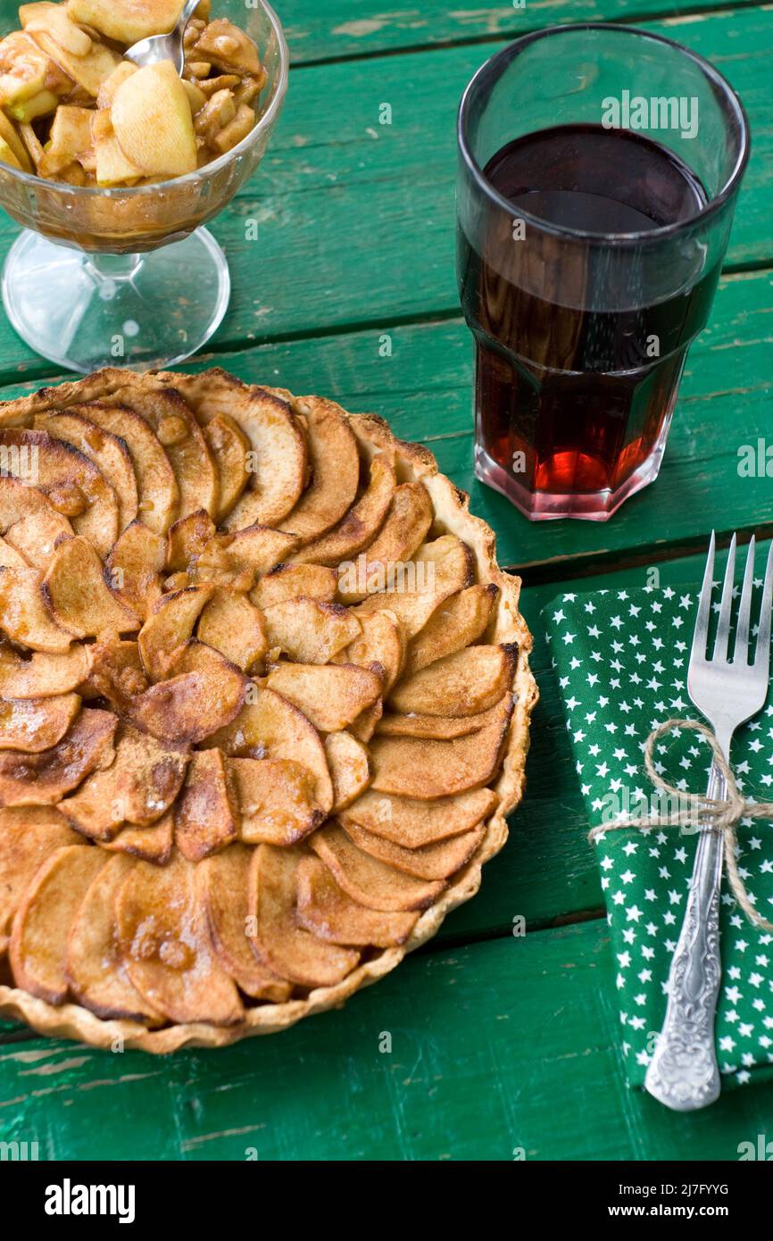 Juicy apple pie with cinnamon and brandy on a green background Stock ...