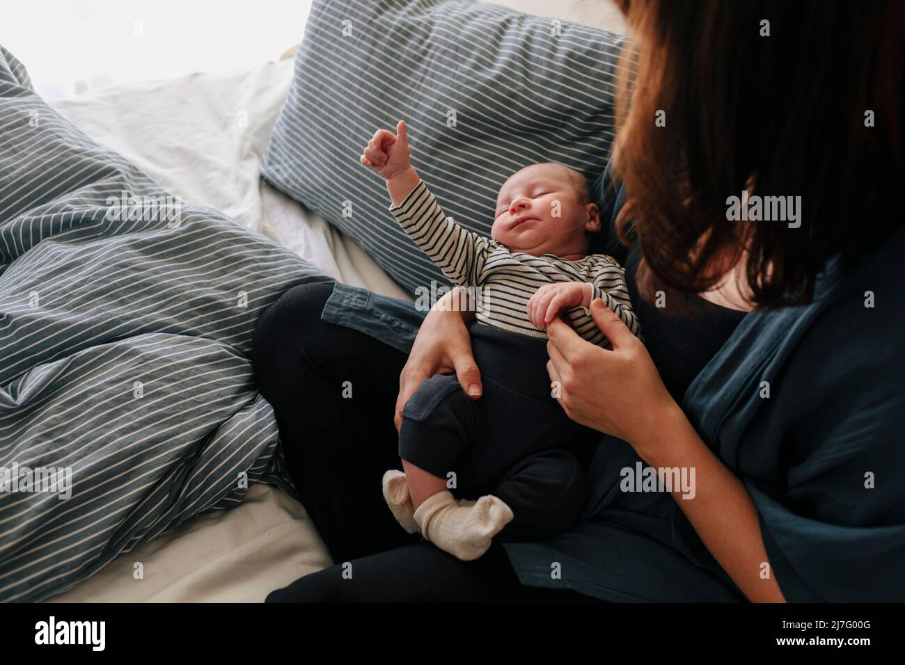 Mother holding sleeping newborn baby Stock Photo - Alamy