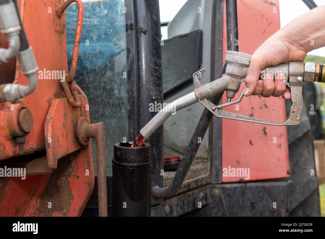 Farmer filling tractor with red Diesel on a farm, North Yorkshire, UK ...