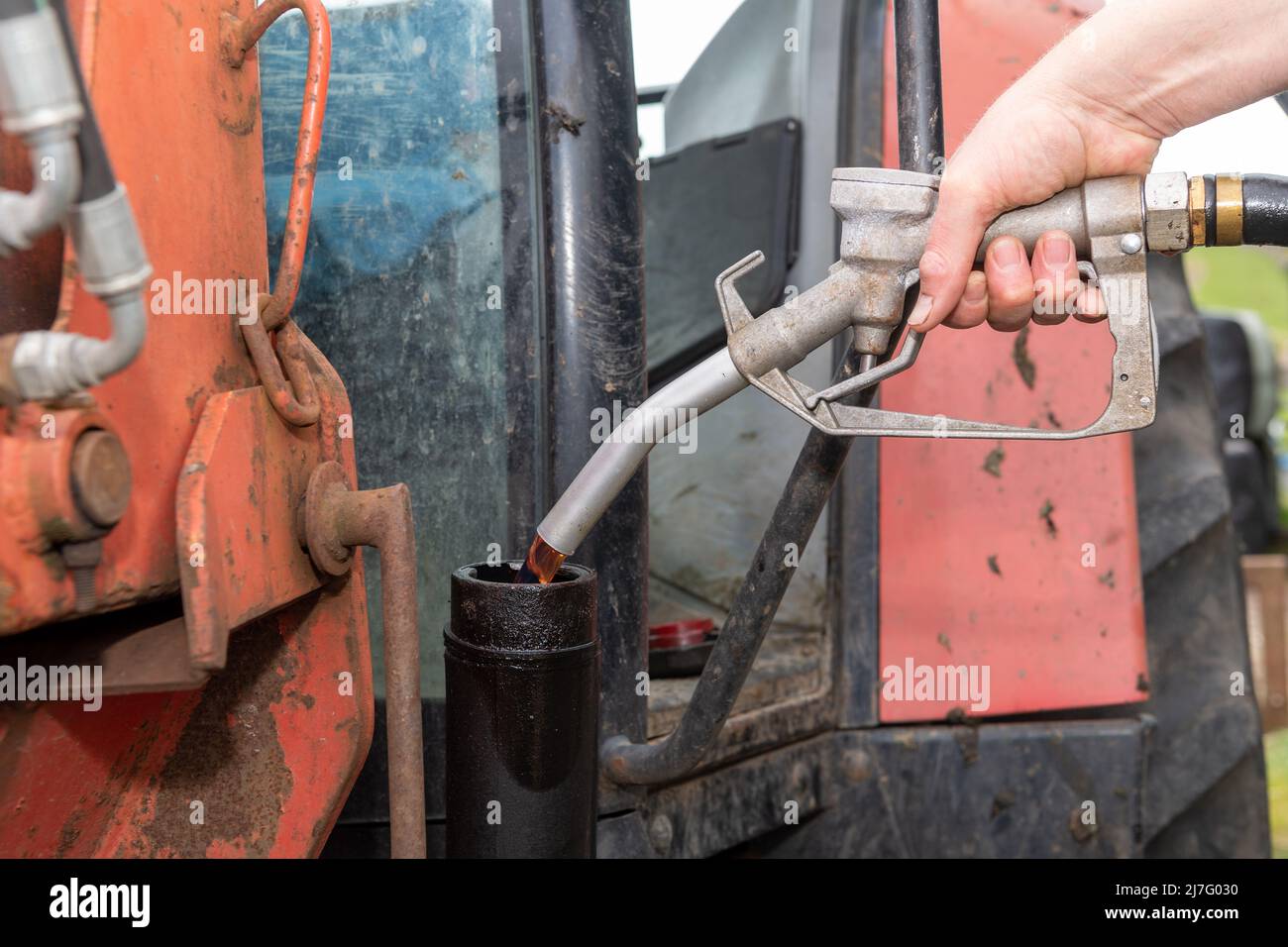 Farmer filling tractor with red Diesel on a farm, North Yorkshire, UK ...