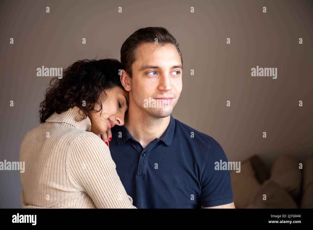 Young couple hug at home hi-res stock photography and images - Alamy