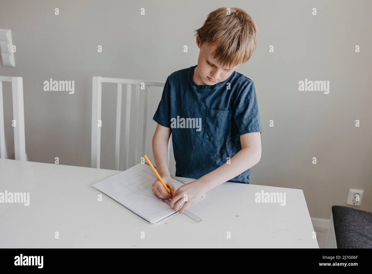 Schoolboy doing homework Stock Photo - Alamy