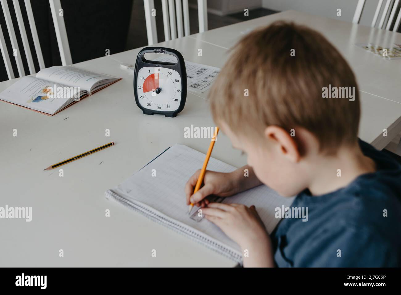 Schoolboy doing homework Stock Photo - Alamy