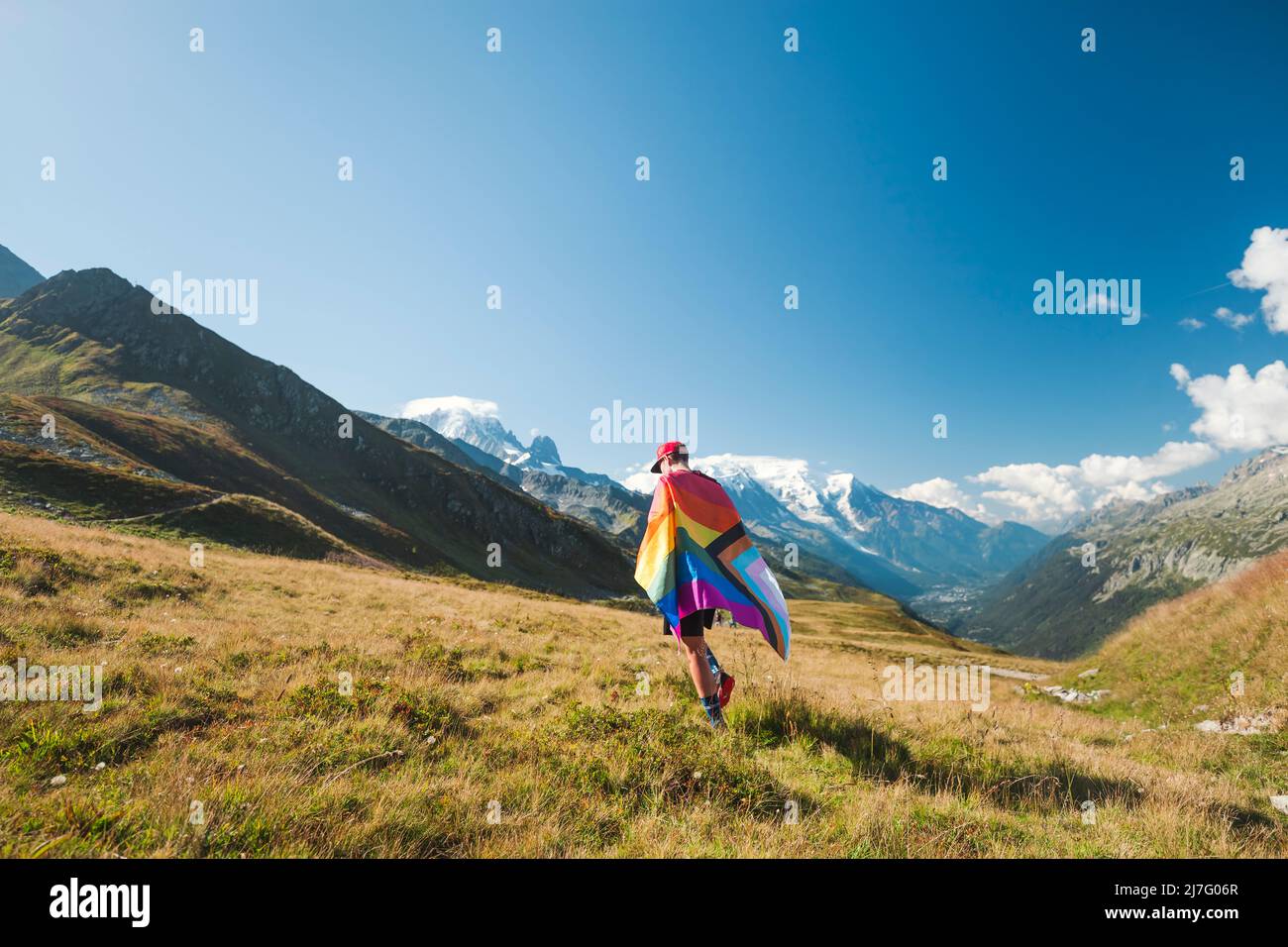 Man with LGBTIQ Community flag in mountains Stock Photo - Alamy