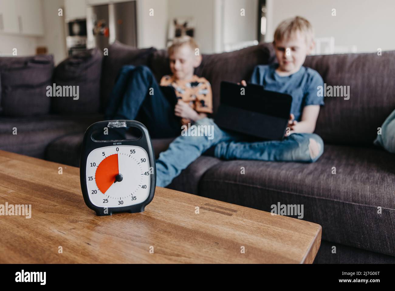 Boys spending time with laptop according to clock Stock Photo - Alamy