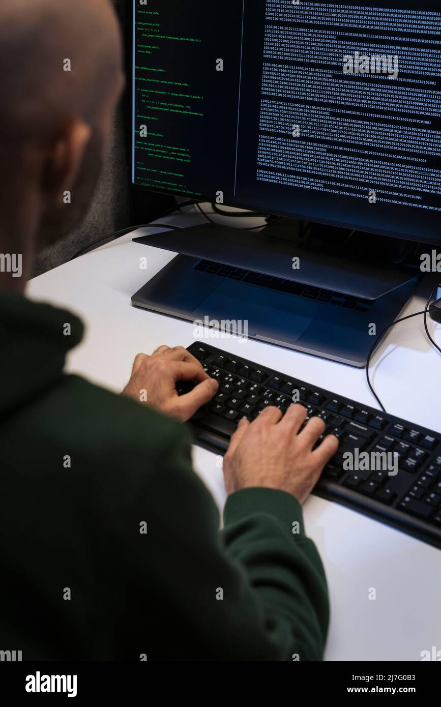 Male programmer working on computer Stock Photo - Alamy
