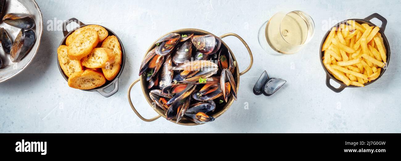Mussels panorama. Seafood meal with shellfish, French fries and toasted ...