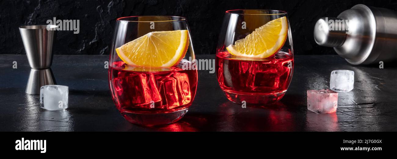 Campari or negroni cocktails on a black slate background with fresh ...