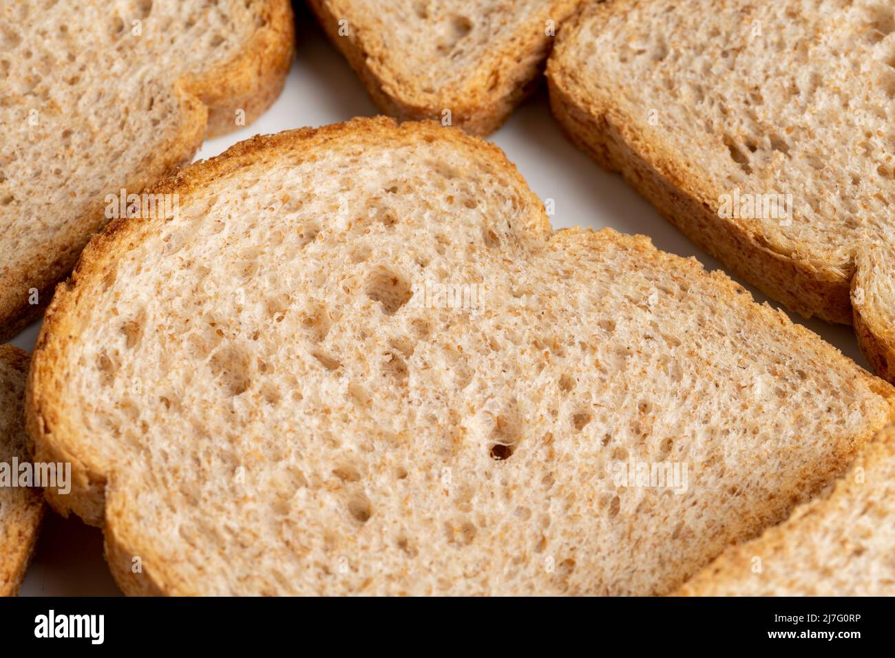 Slices of brown bread baked from wheat flour on a white plate Stock ...