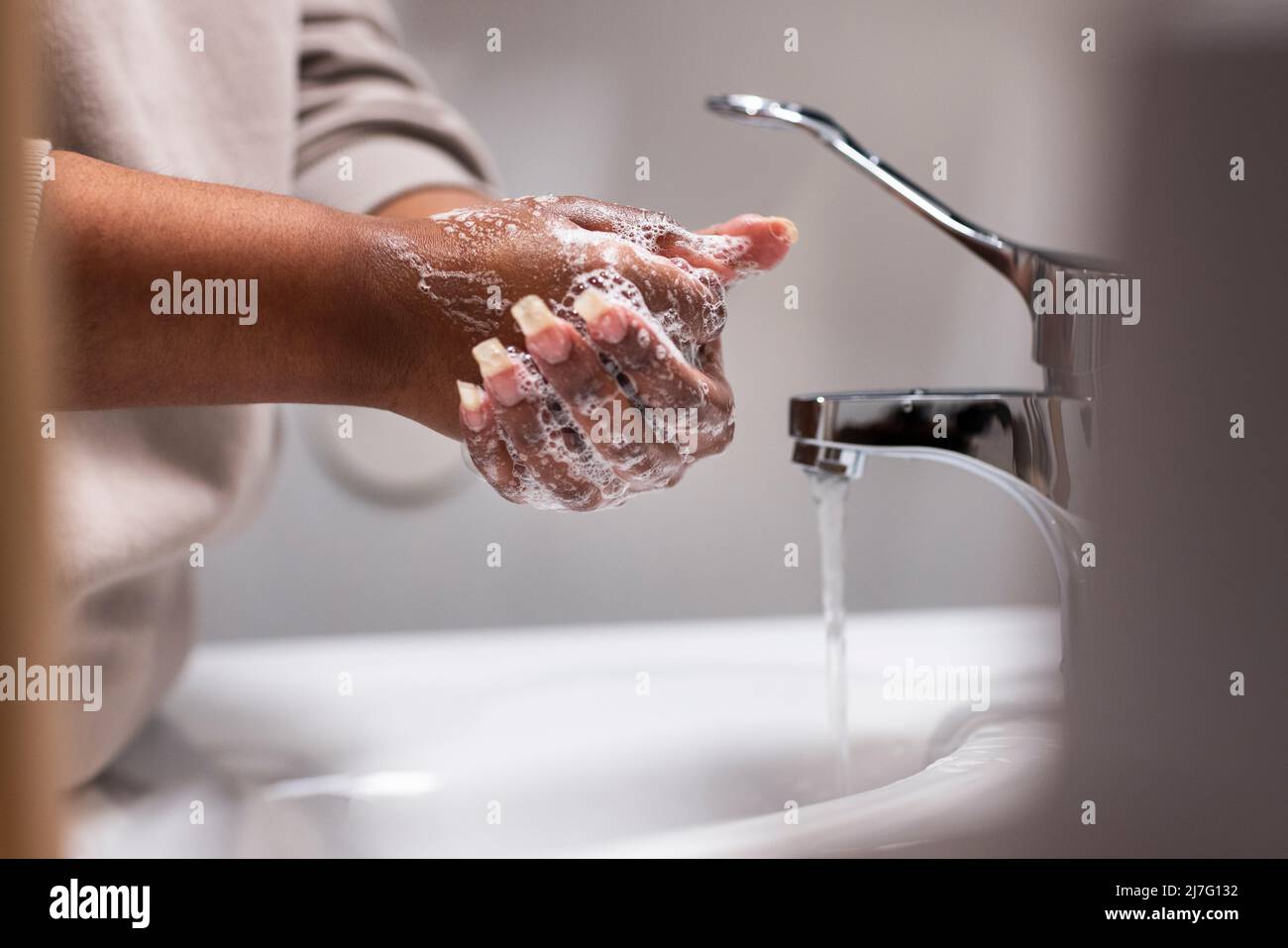 Mid section of woman washing hands Stock Photo - Alamy