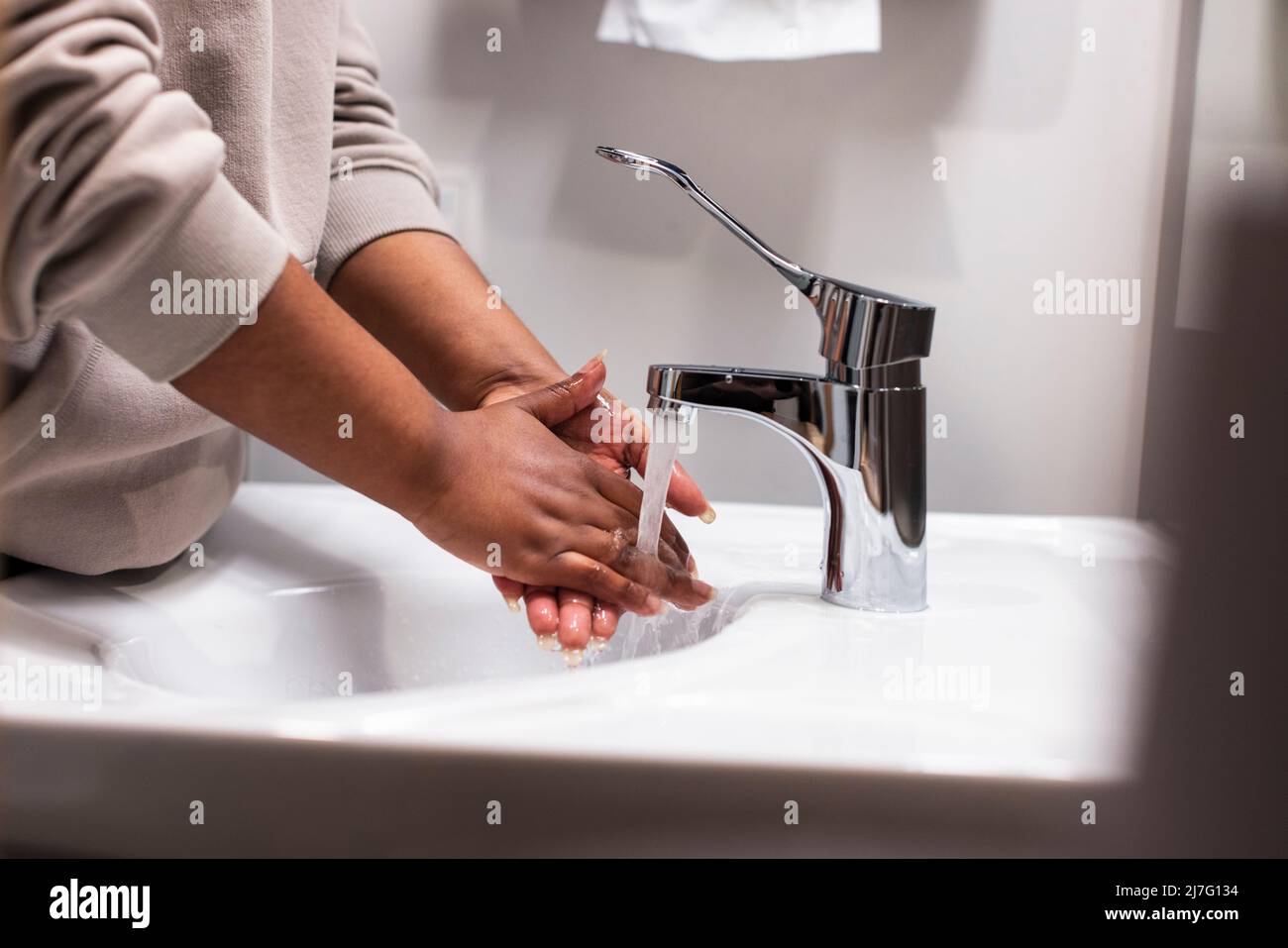 Mid section of woman washing hands Stock Photo - Alamy