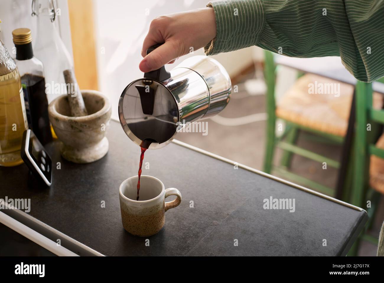 Woman pouring coffee into cup Stock Photo - Alamy