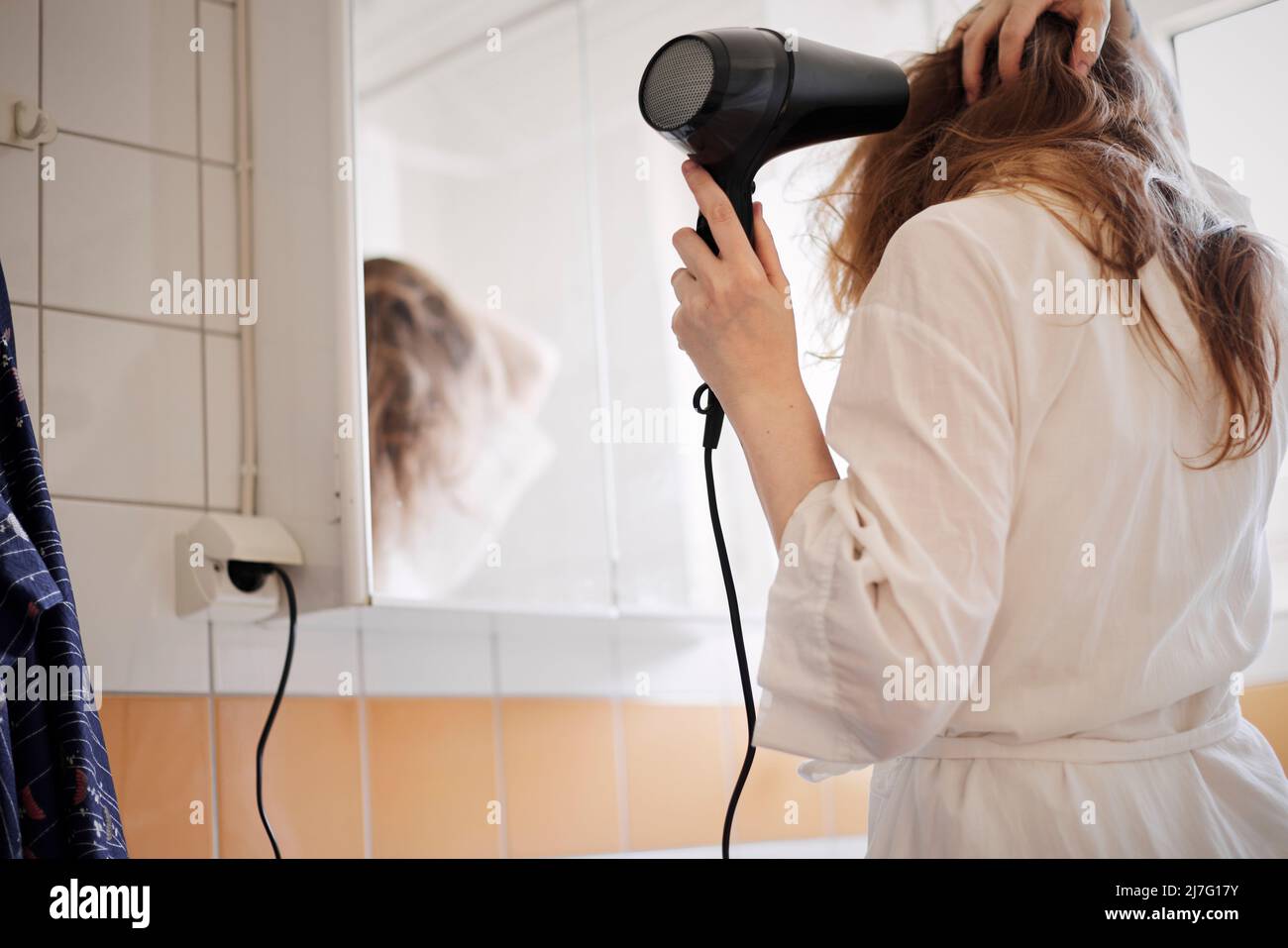 Woman drying hair Stock Photo - Alamy