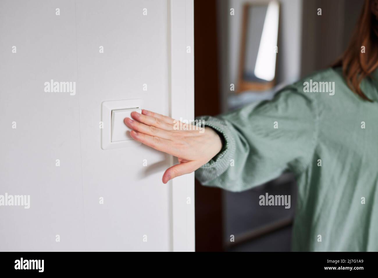Hand pressing light switch Stock Photo - Alamy