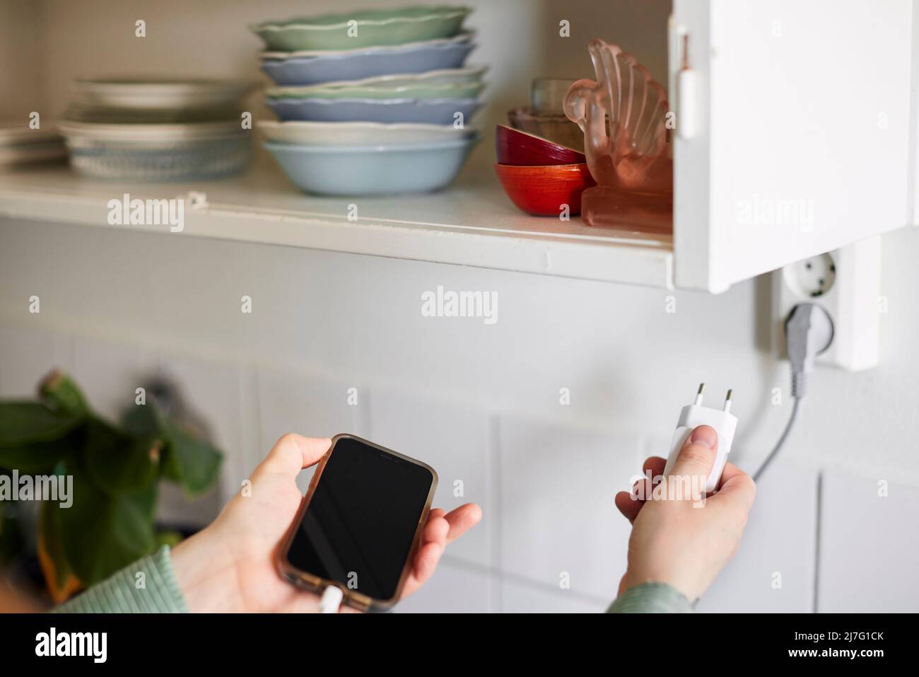 Hand plugging in or out an electric cord into socket Stock Photo - Alamy