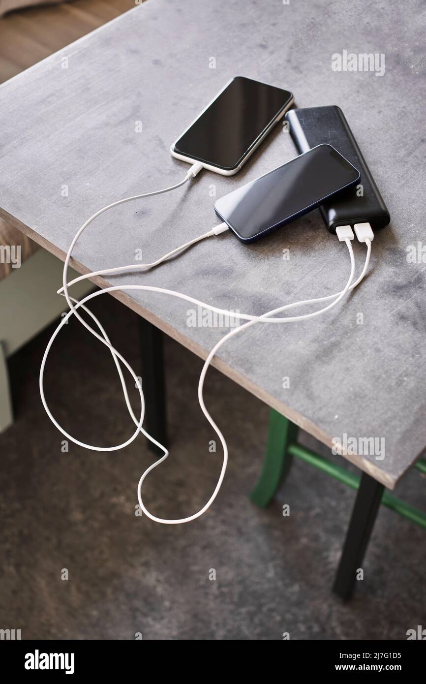 Cell phones connected to power bank Stock Photo - Alamy