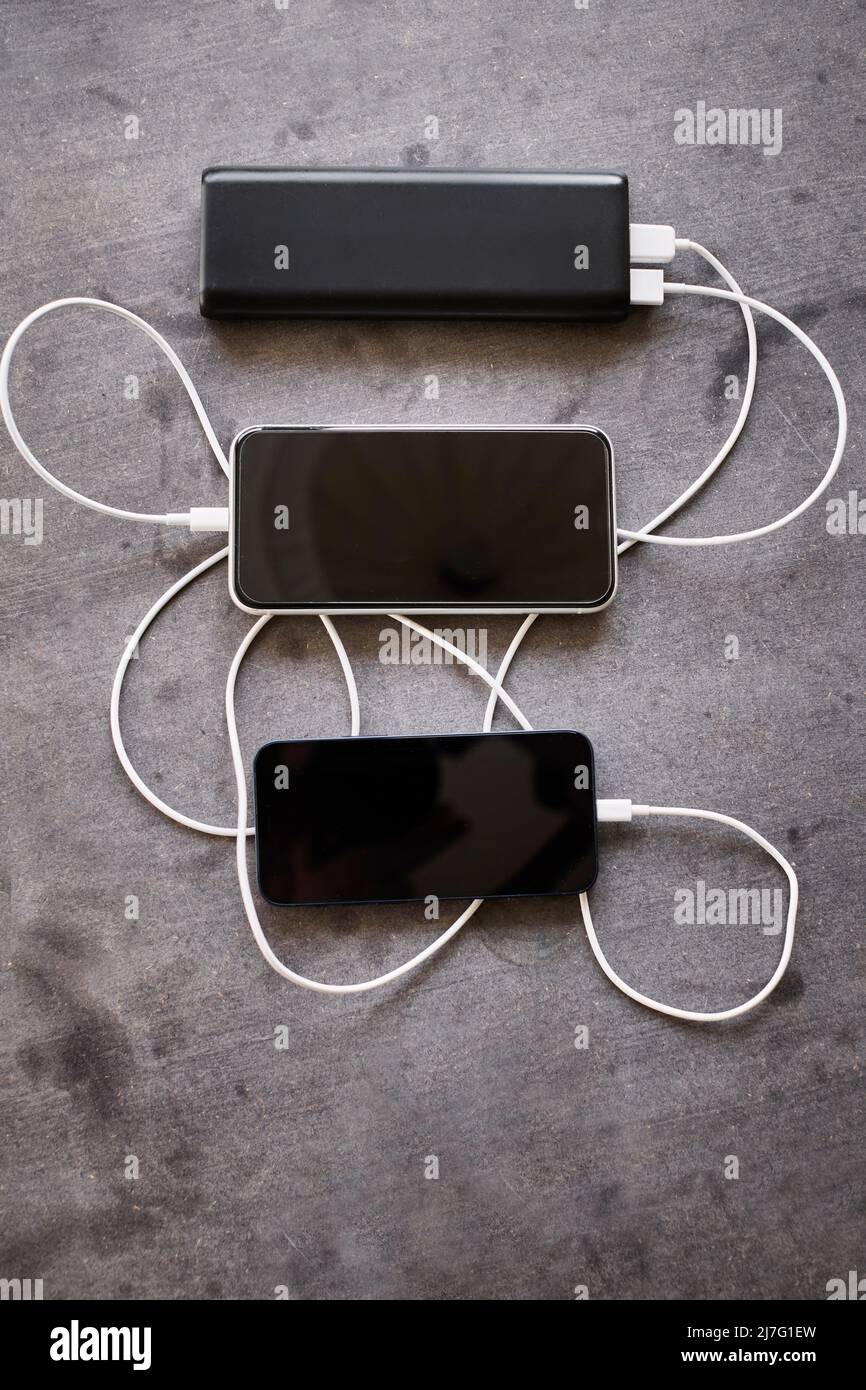 Cell phones connected to power bank Stock Photo - Alamy