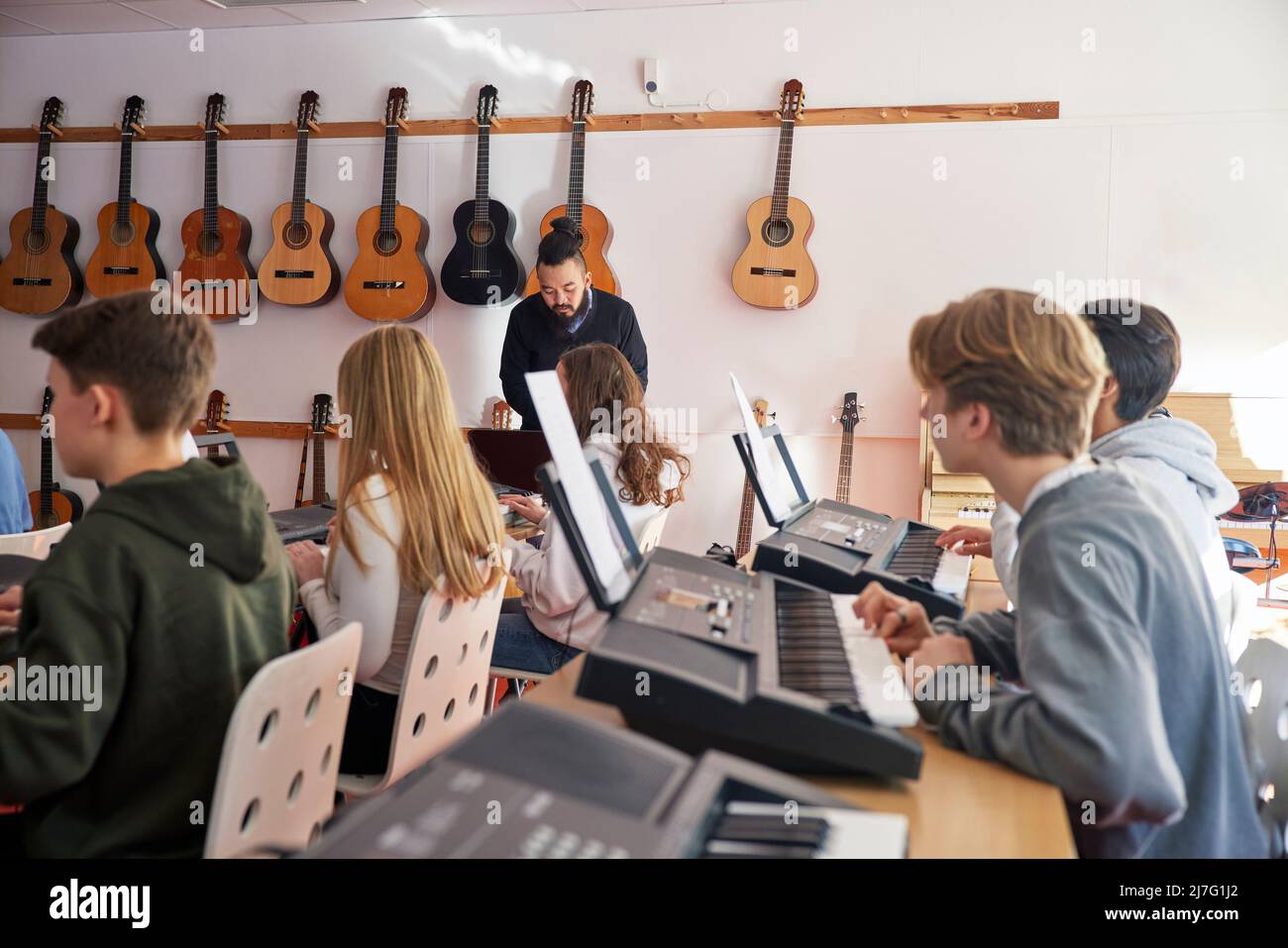 Teenagers attending keyboard lesson Stock Photo - Alamy