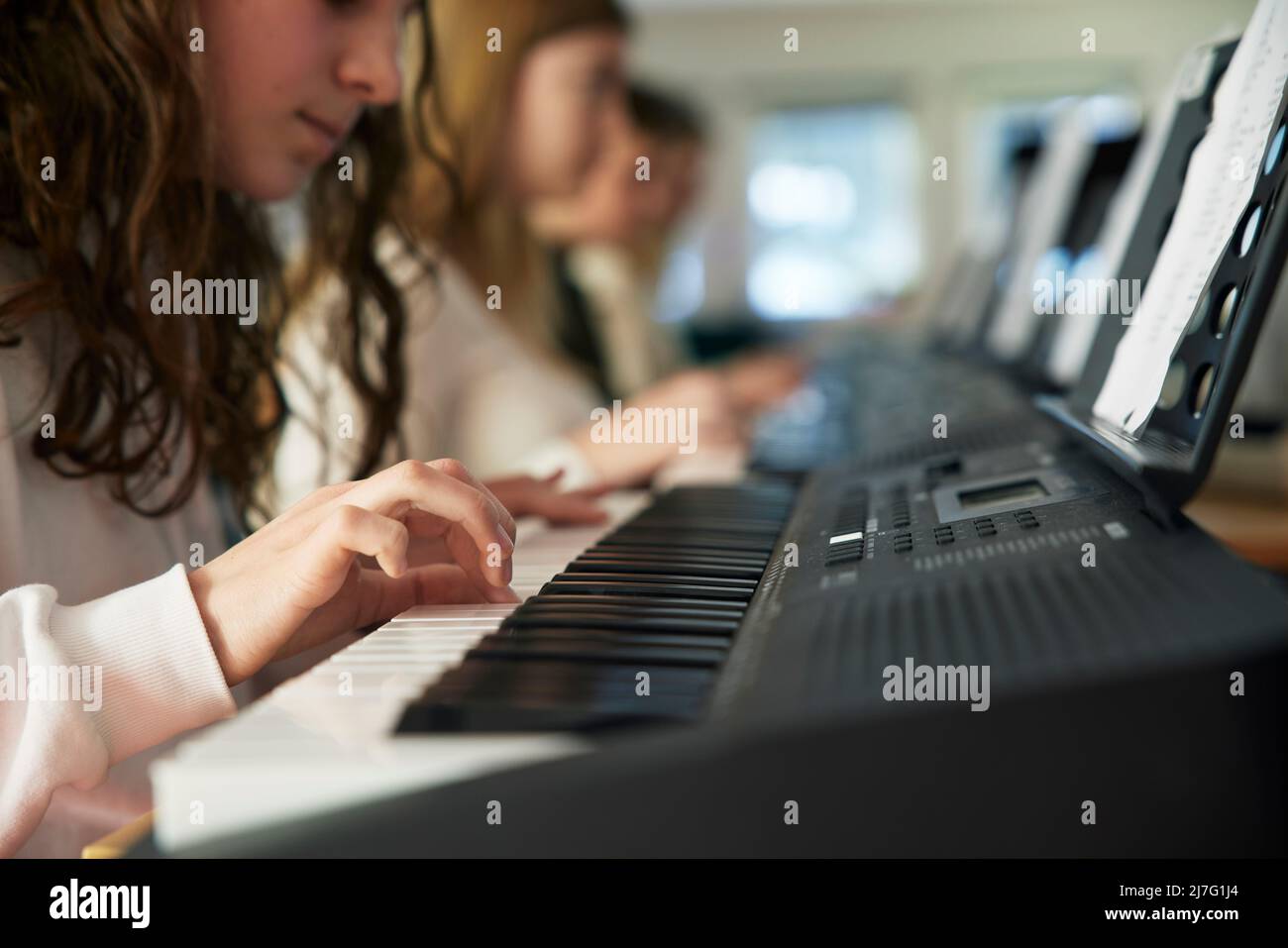 Teenage girl attending keyboard lesson Stock Photo - Alamy