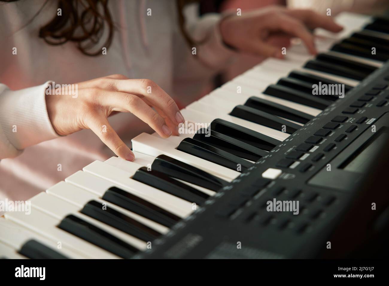 Teenage girl attending keyboard lesson Stock Photo - Alamy