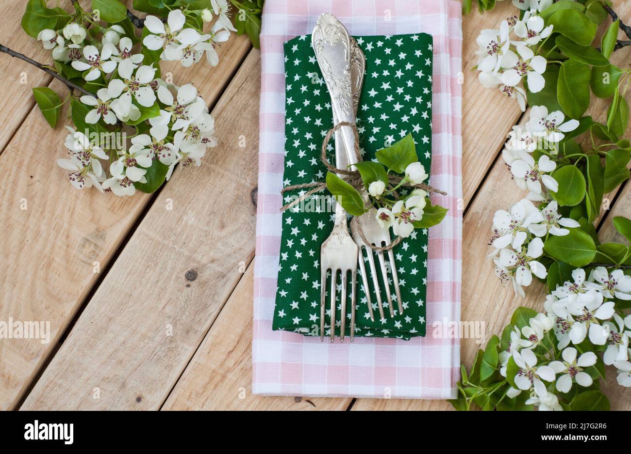 Two forks on rustic wooden background and branches with flowers Stock ...