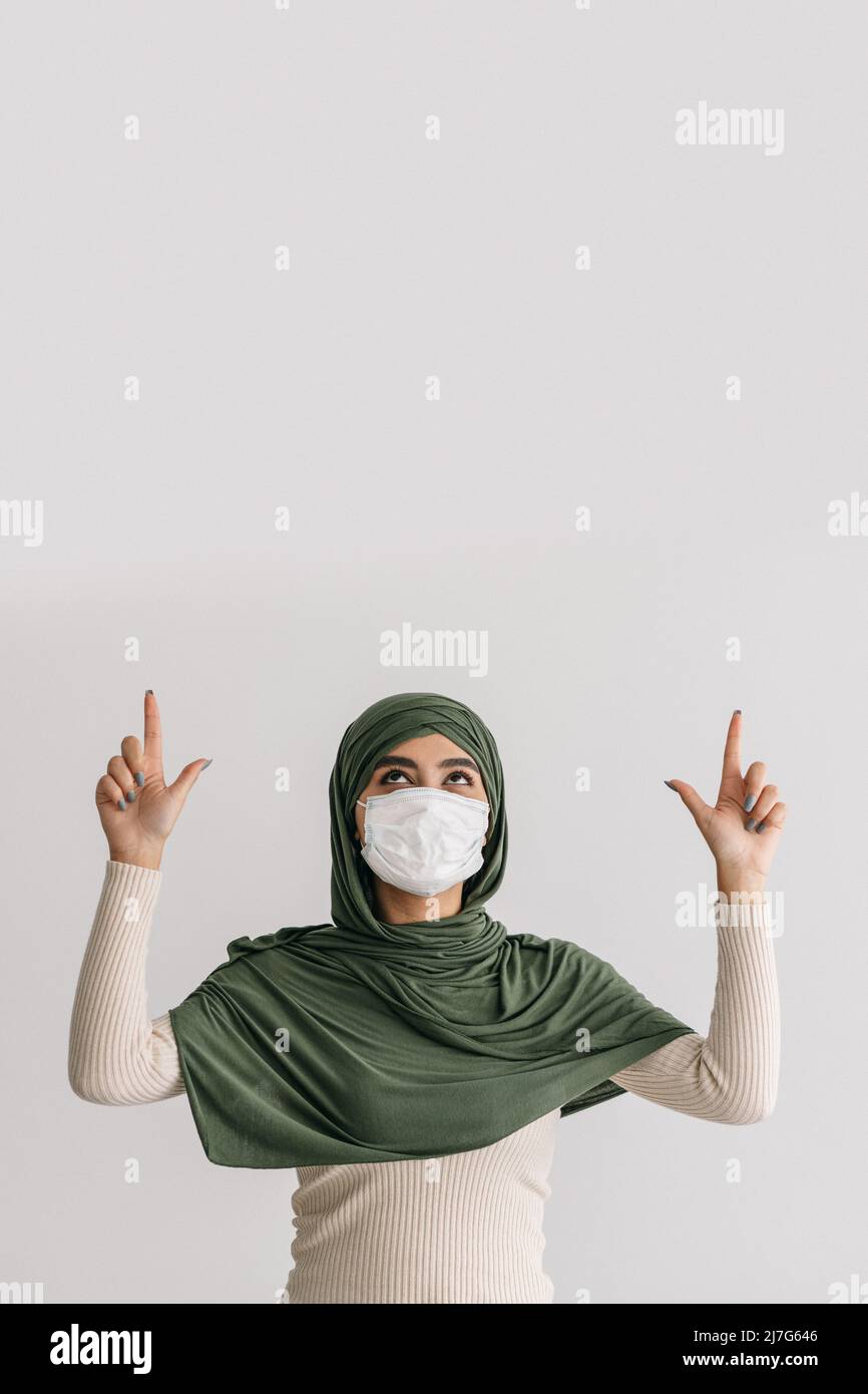 Coronavirus protection. Young Arab woman in hijab and antiviral face ...