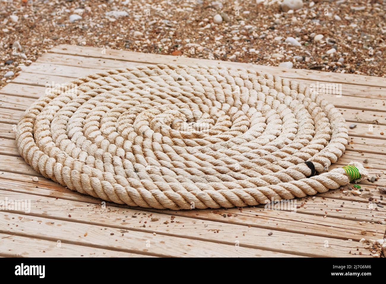 Folded sea rope lies on the seashore Stock Photo - Alamy