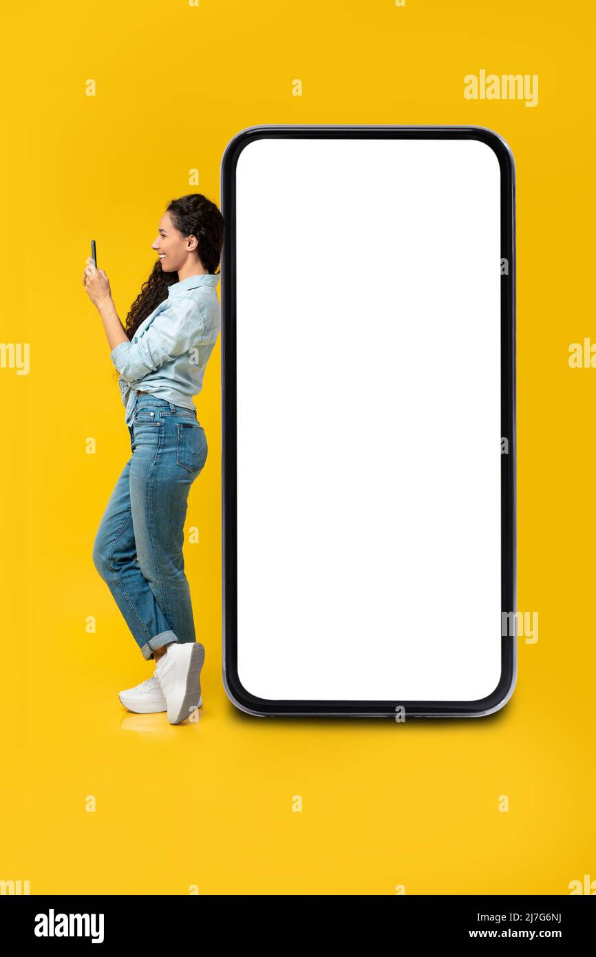 Happy lady using mobile phone at studio, mockup Stock Photo - Alamy