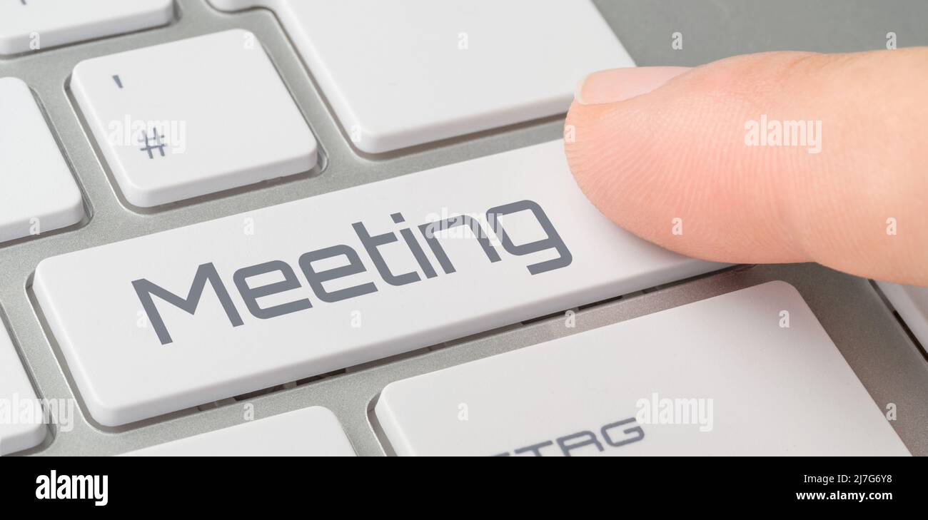 A keyboard with a labeled button - Meeting Stock Photo - Alamy
