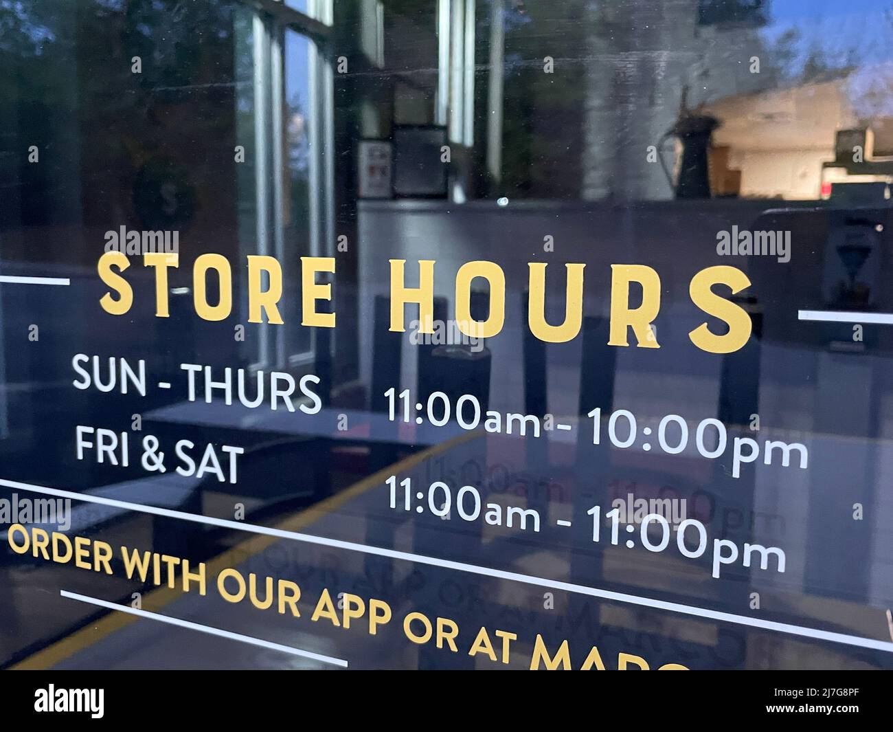 Augusta, Ga USA - 04 27 22: store hours sign on a glass door Stock ...