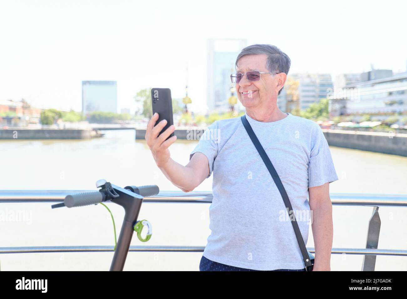 Hispanic senior man sightseeing in Buenos Aires, Argentina and taking a ...