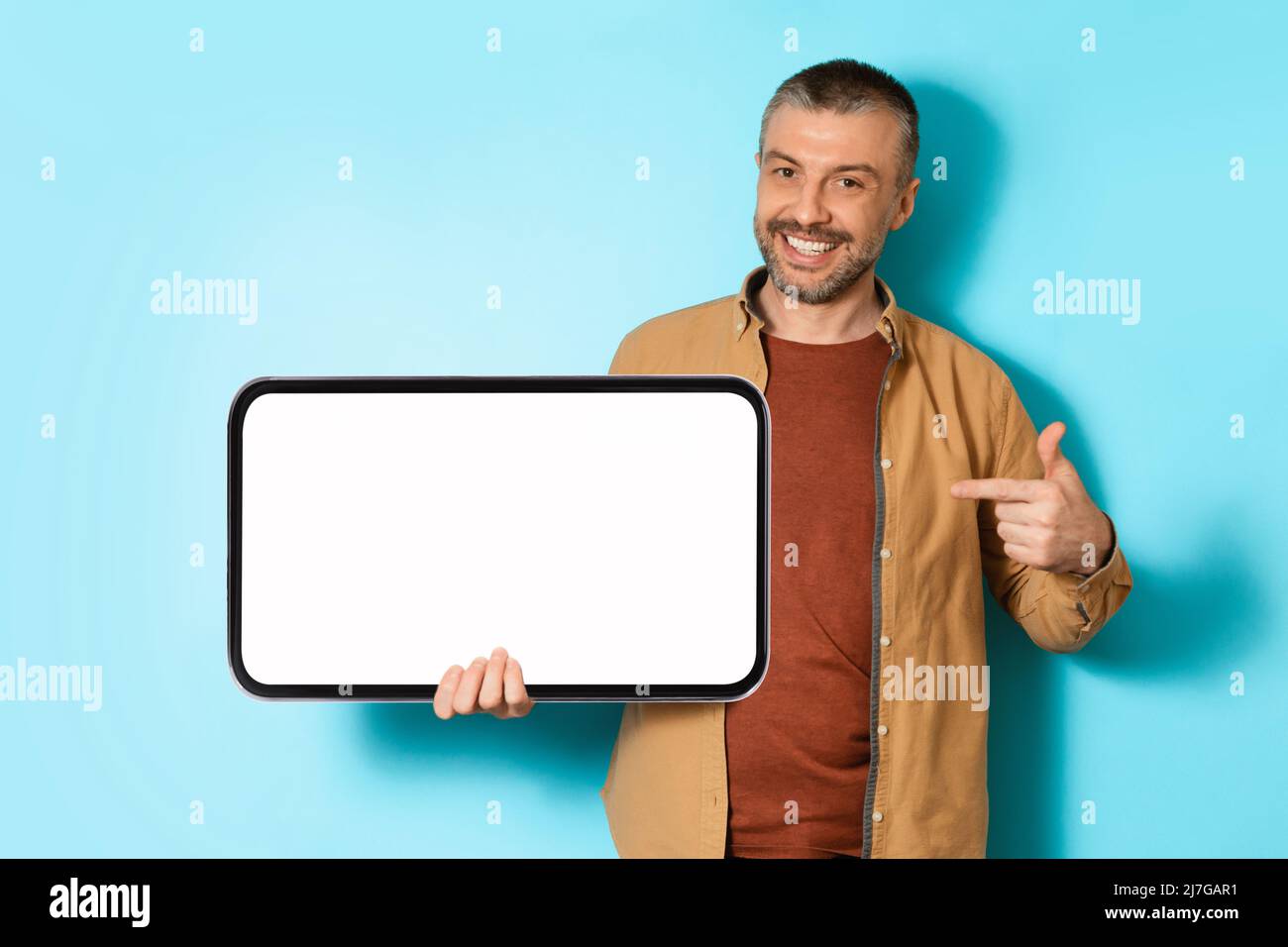 Joyful Man Holding Big Mobile Phone Showing Screen, Blue Background ...